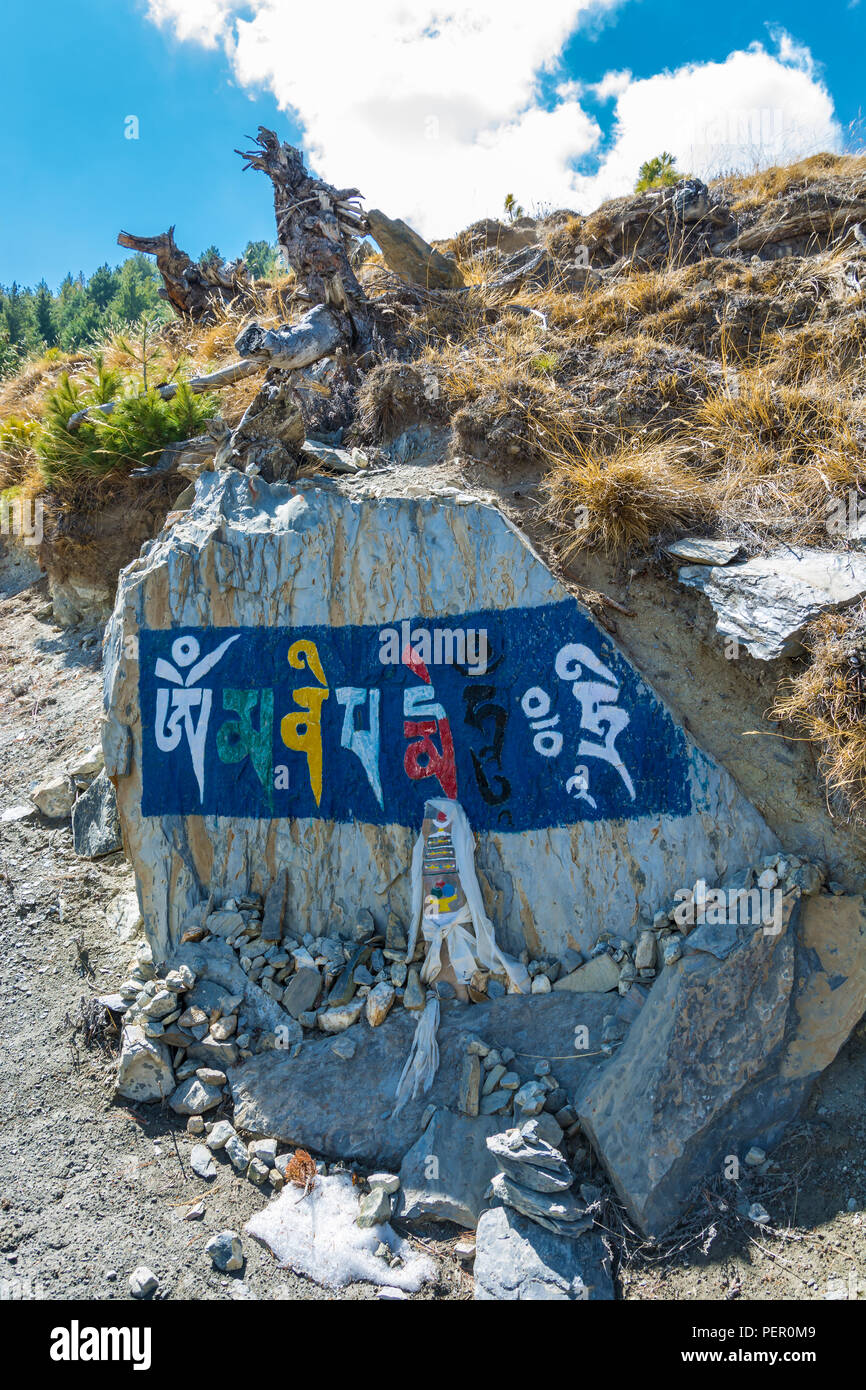 Colored inscriptions on stones in the mountains of Nepal on a Sunny day ...