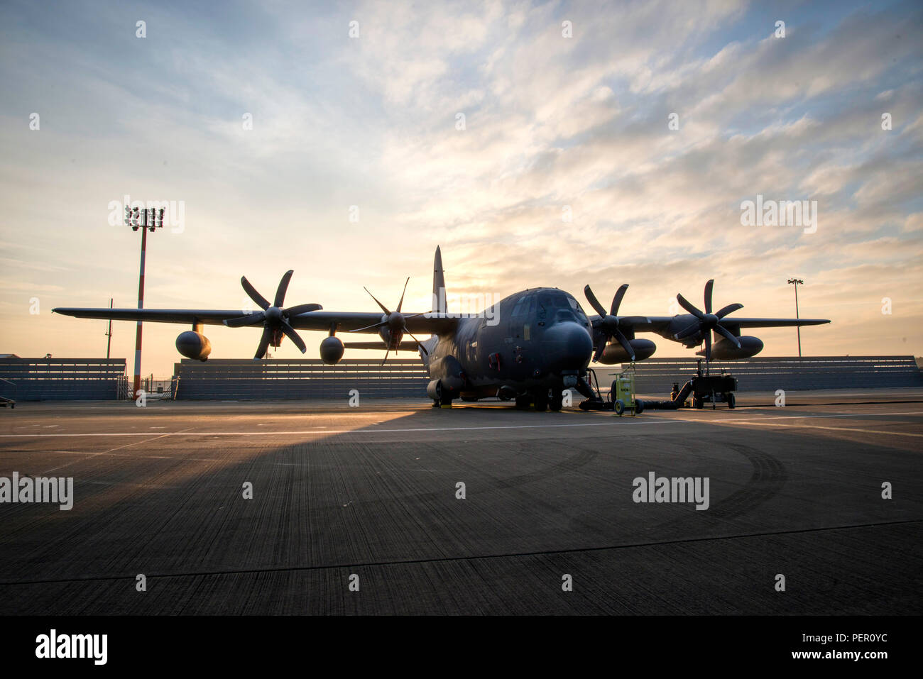 The sun rises over a frost covered MC-130J Commando II, Jan. 21, 2016 ...