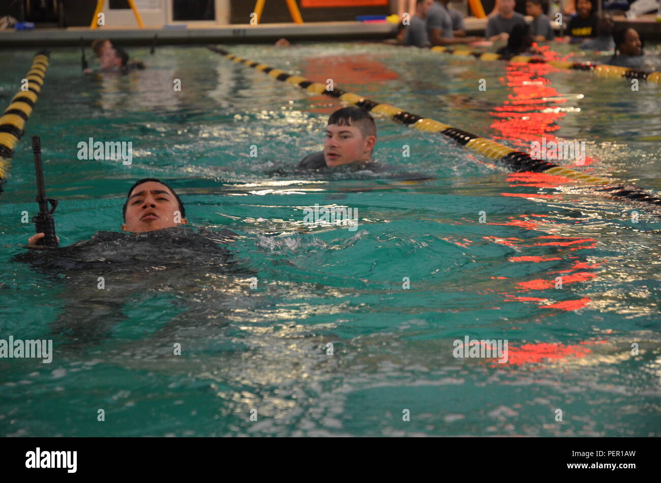 Soldiers from HHB, 18th Field Artillery Brigade swim down a pool lane ...