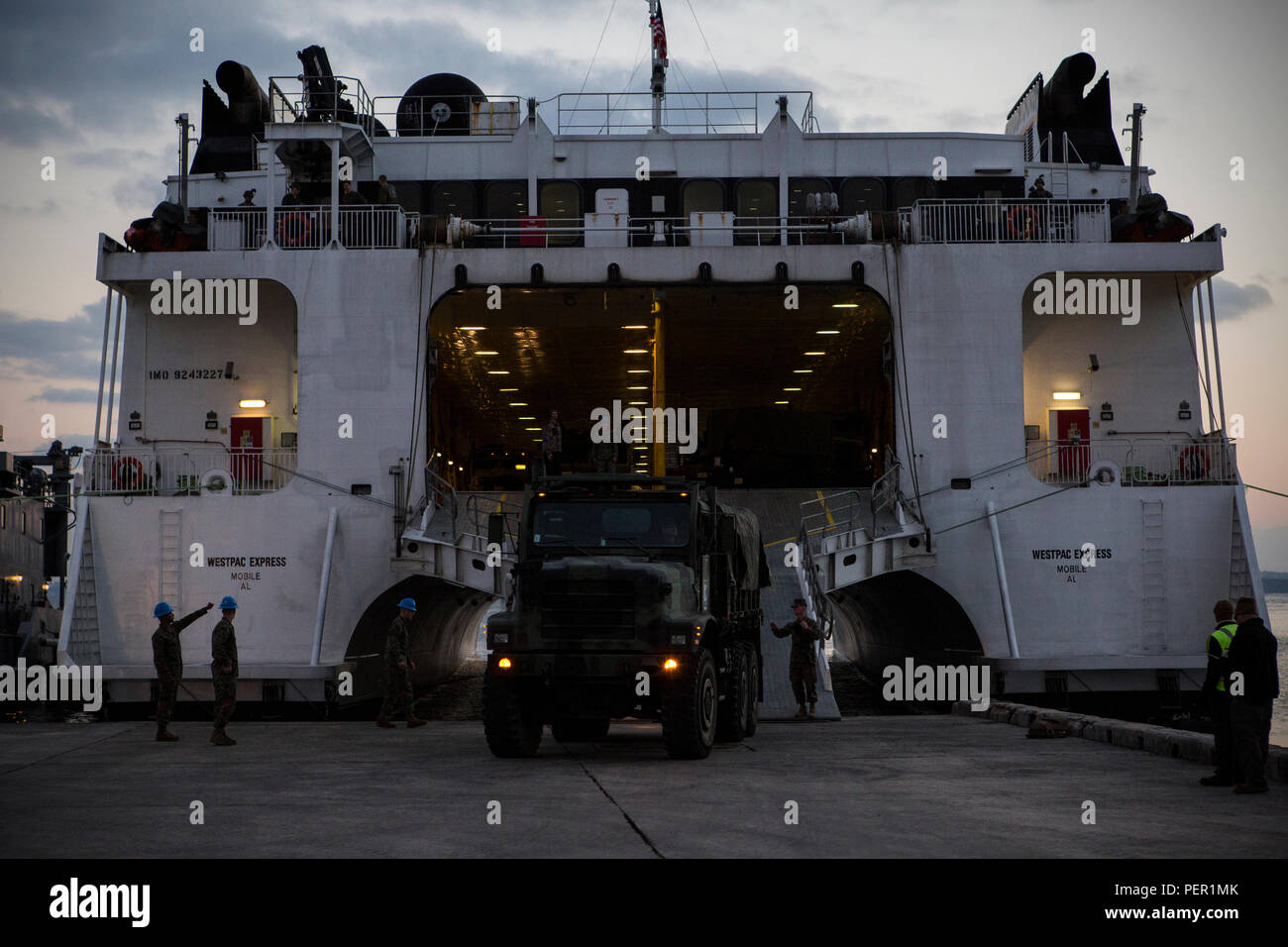 U.S. Marines with 1st Battalion, 3rd Marine Regiment, load the MV ...