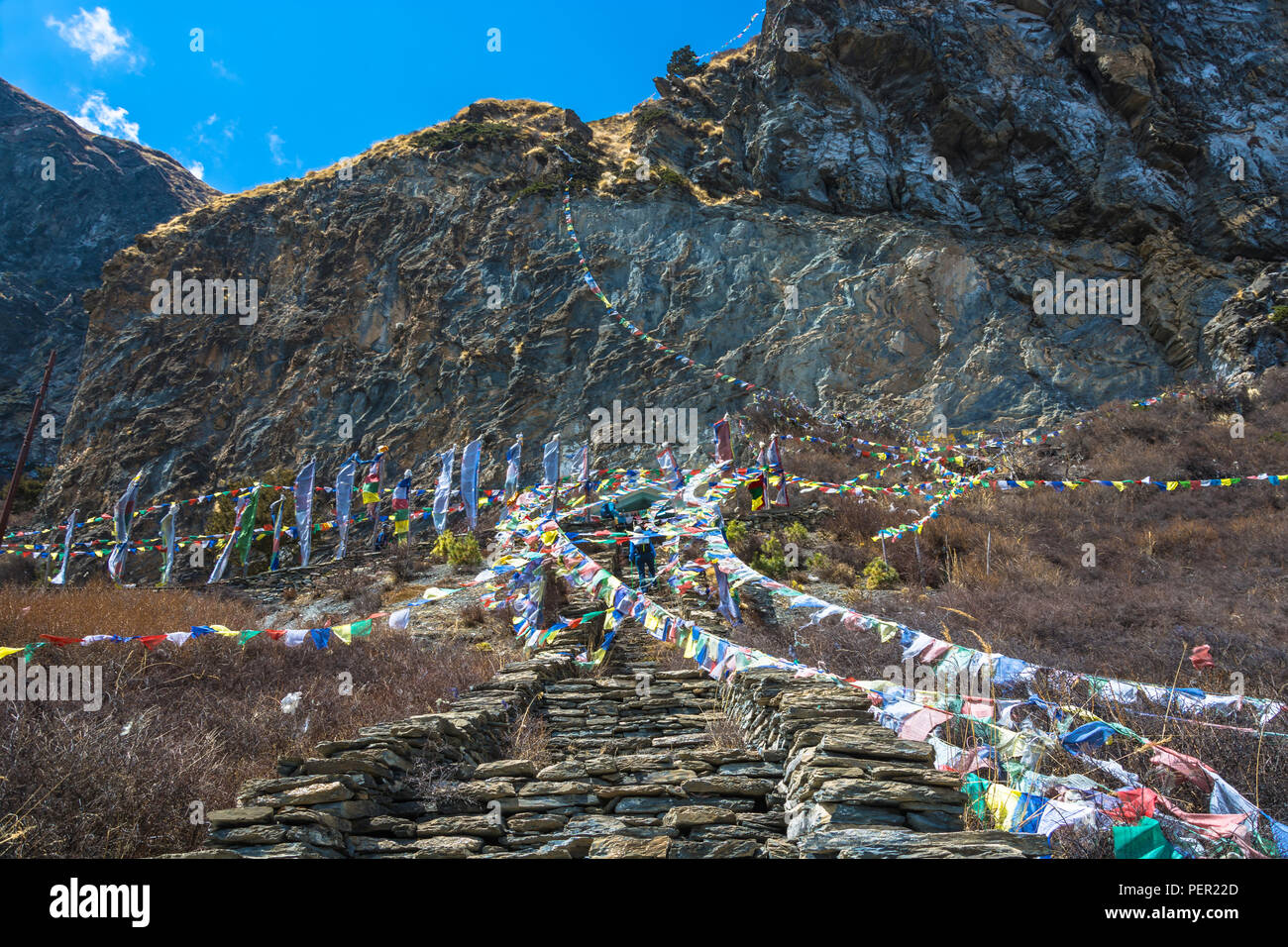Stone staircase decorated with colorful flags and leading to Milarepa ...