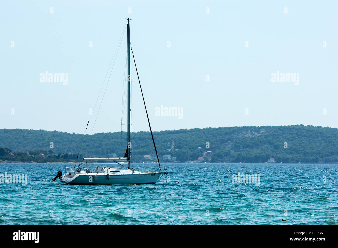 A picture of several boats floating on the blue ocean during the hot ...