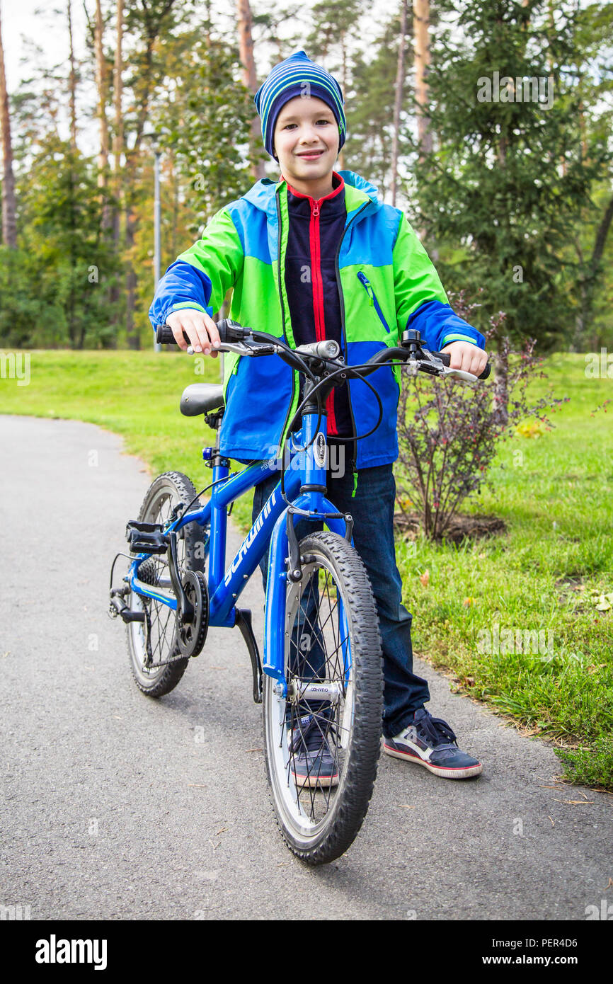 Happy boy riding a bicycle in the park Stock Photo - Alamy