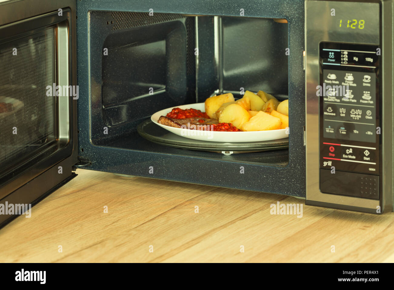 Microwave oven with a heated meal Stock Photo - Alamy