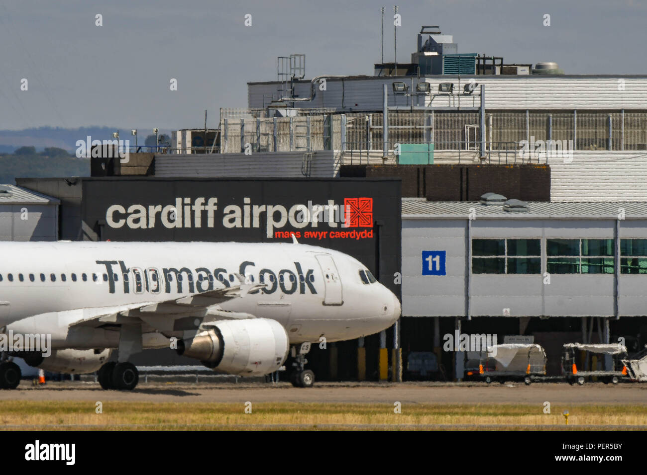 Thomas Cook holiday jet in front of the Cardiff Airport sign on the ...