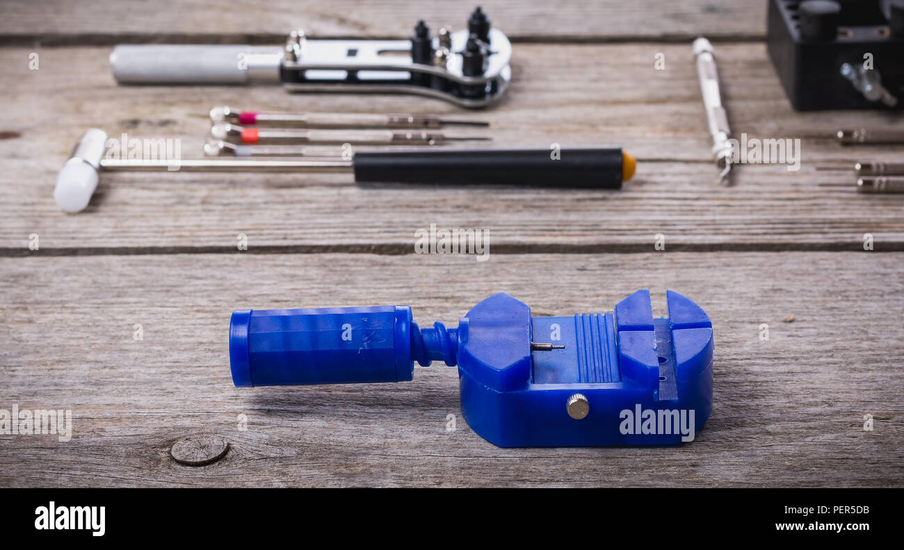 Set of watchmaker tools isolated on a rough wooden board close up Stock ...