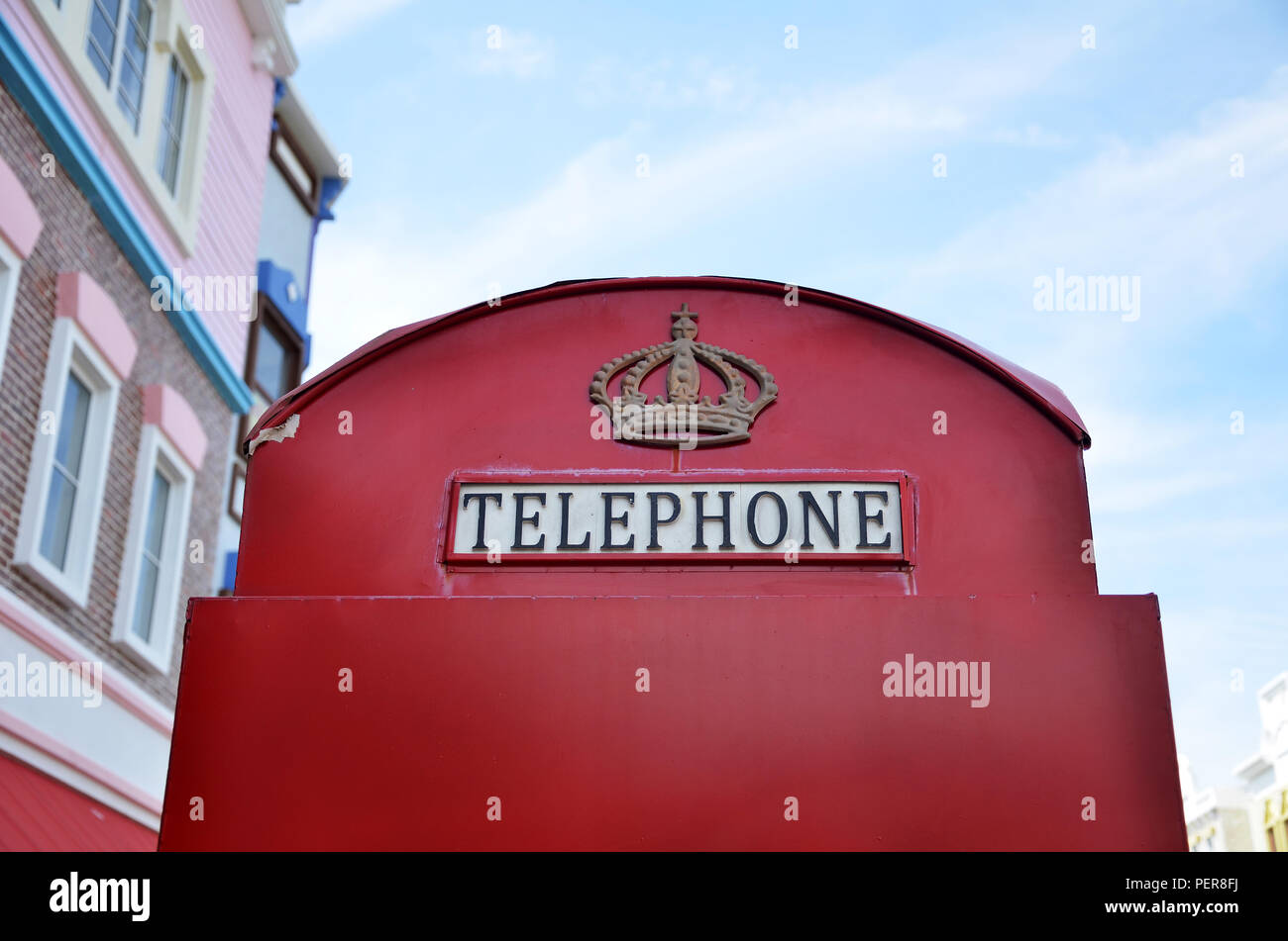 Iconic red telephone box with telephone word on top Stock Photo - Alamy