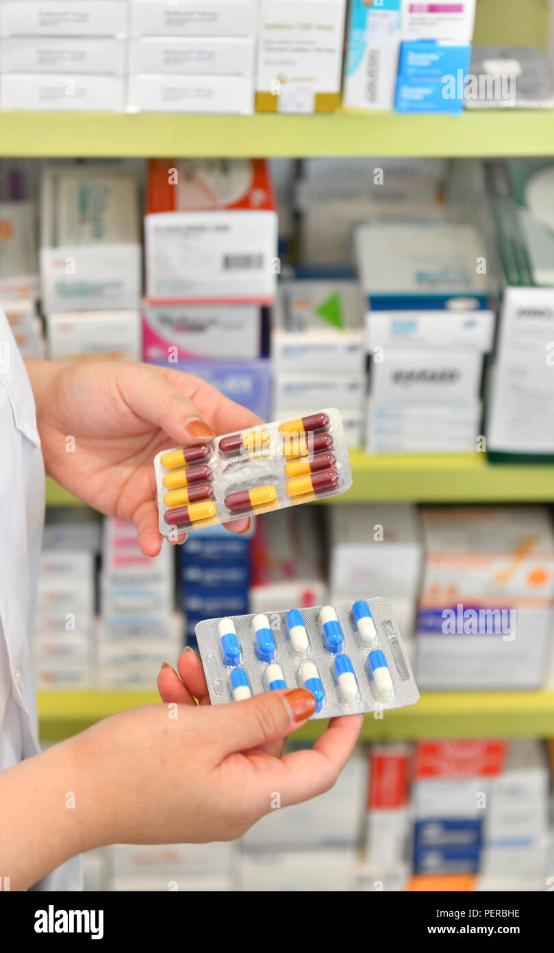Hand holding medicine capsule pack at the pharmacy drugstore Stock ...