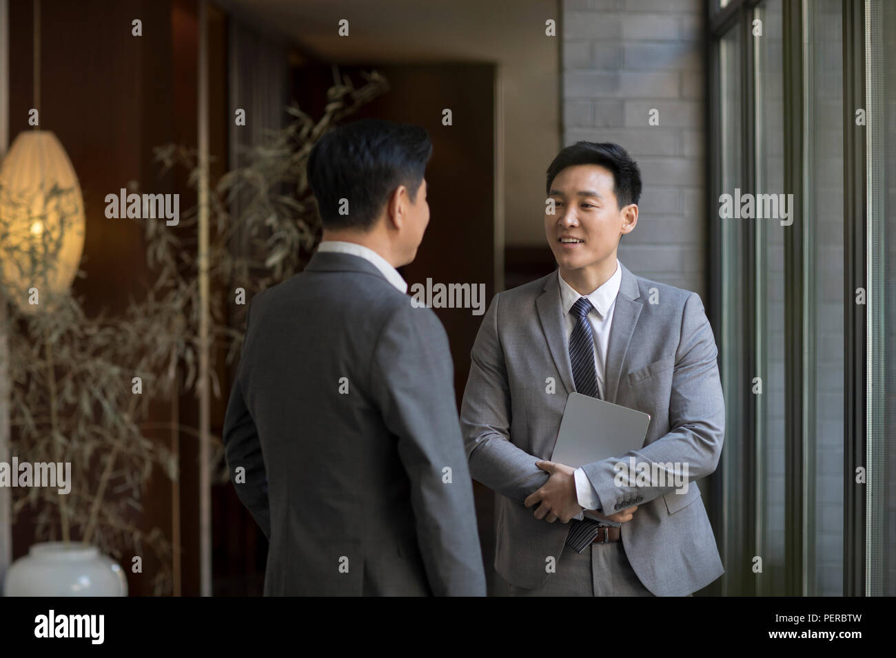 Over shoulder two businessmen talking hi-res stock photography and ...