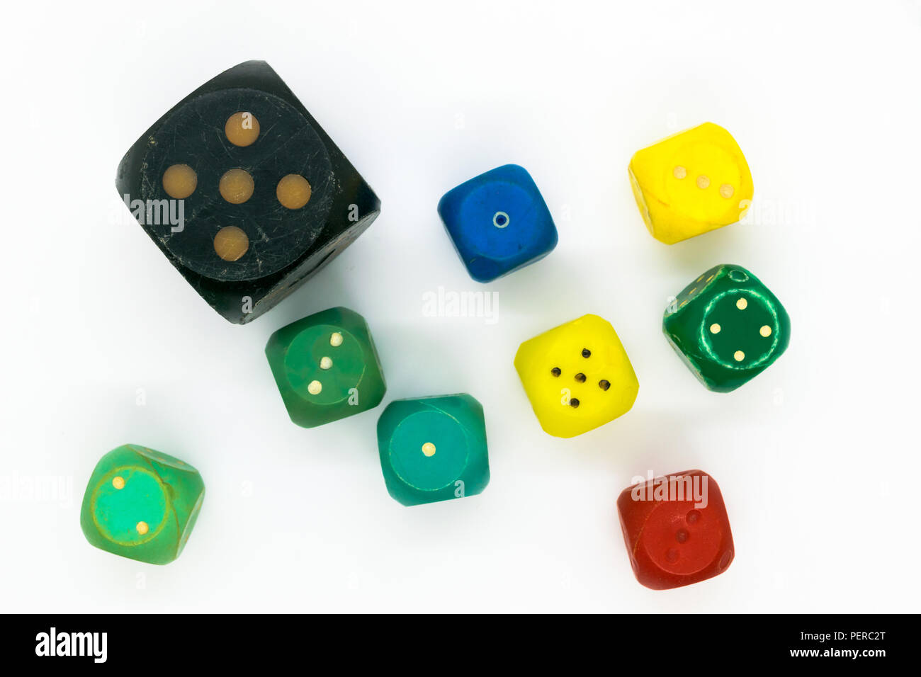 Very old and various colors plastic gaming dice on white background ...