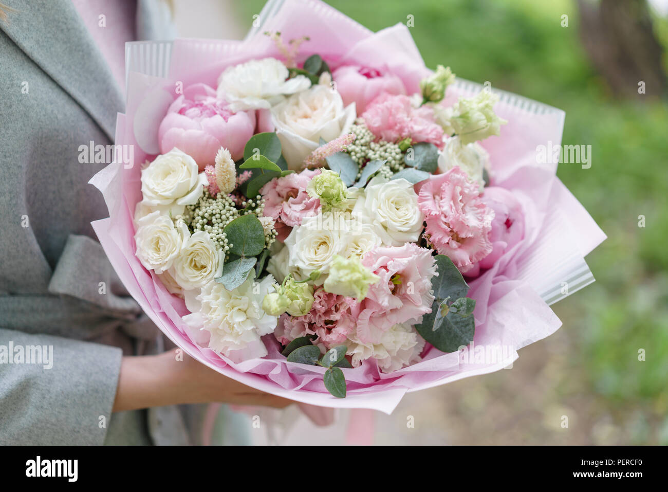 Young girl holding a beautiful spring bouquet. flower arrangement with ...