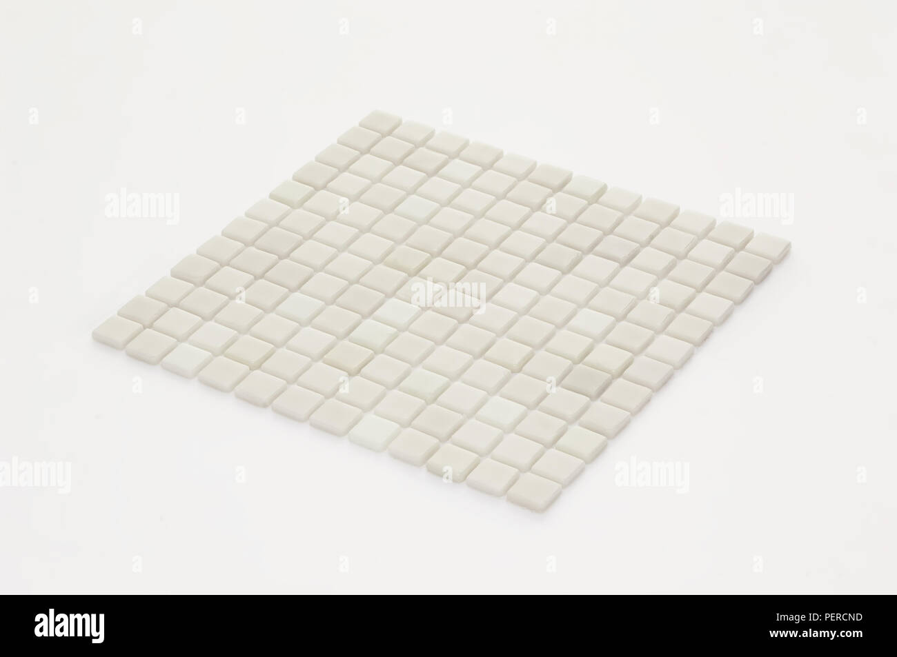 little white ceramic tile on a light background, majolica. for the ...