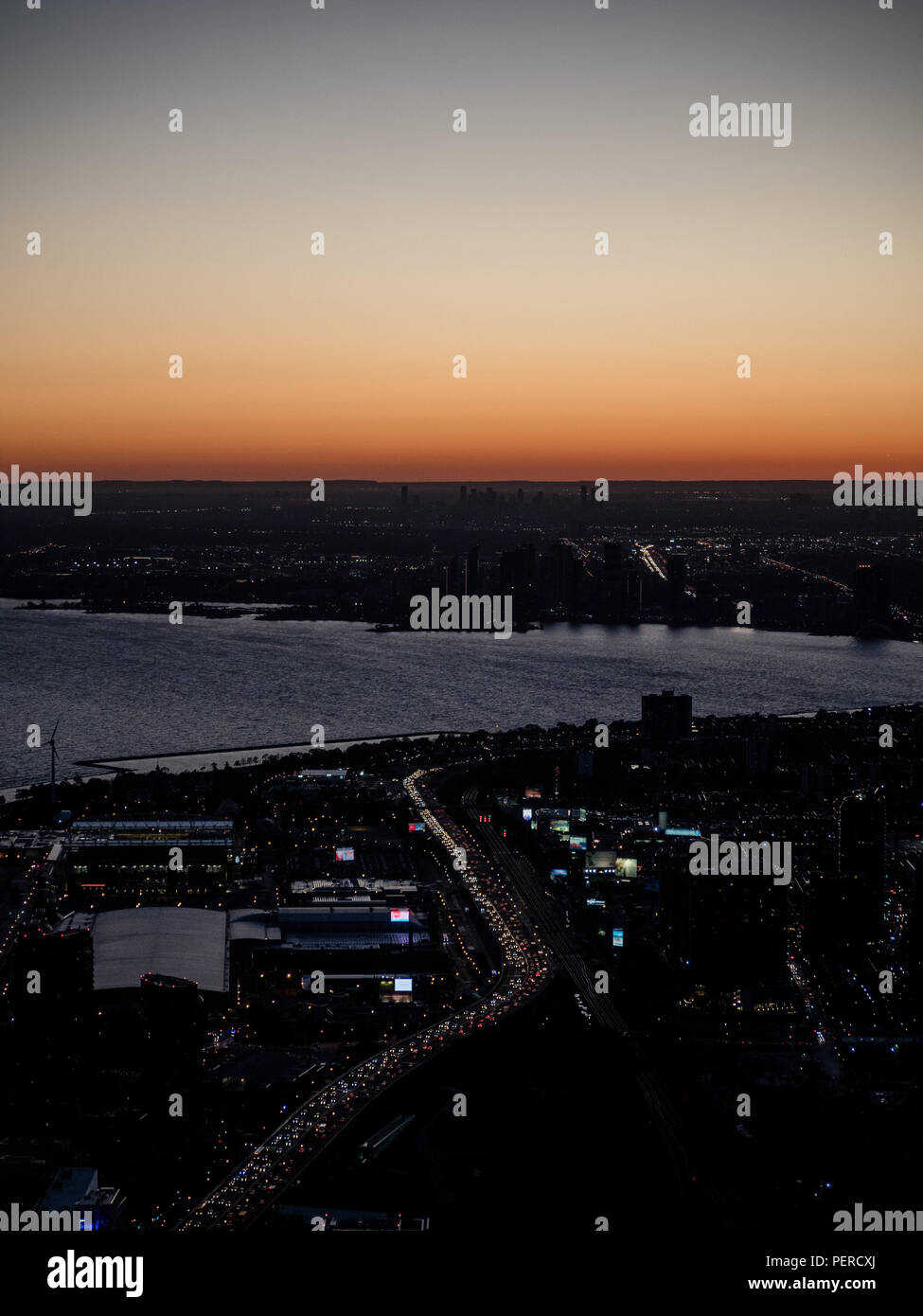 vertical view from cn tower to toronto downtown during dawn sunset with ...
