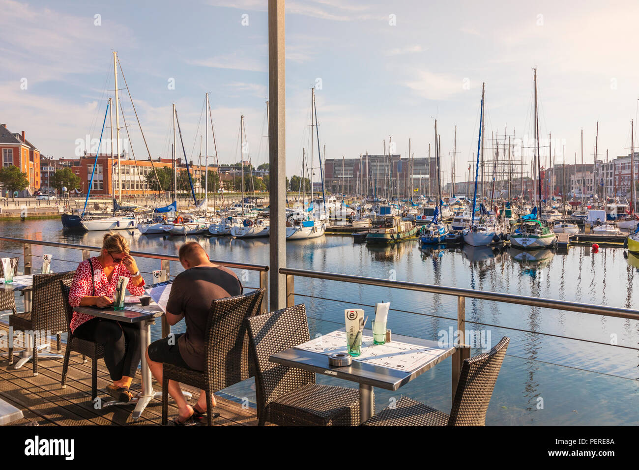 Customers in a quayside restaurant overlooking the yacht marina at ...