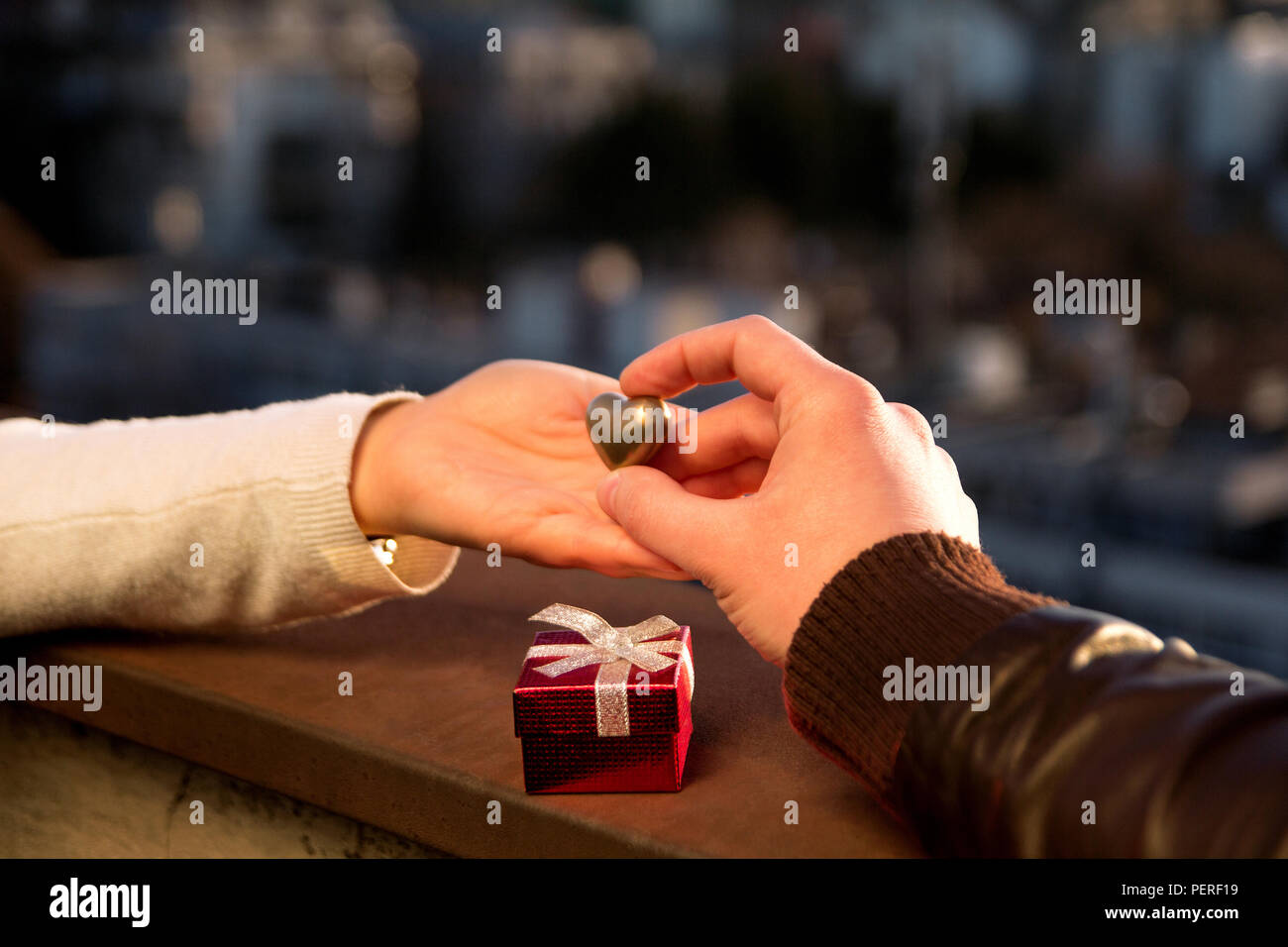 Valentine's Day. Close up of hand waiting a heart and man hand holding ...