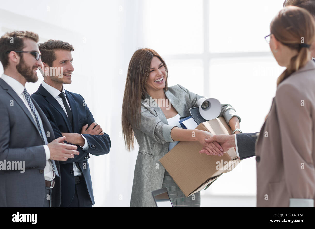 project Manager shaking hands with the new employee Stock Photo - Alamy