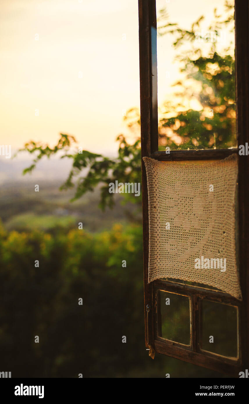 Old open wooden window with homemade embroidery as decoration, blurry ...
