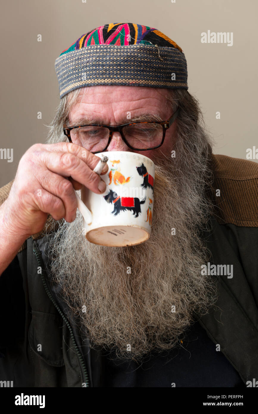 Elderly man smoking and drinking tea Stock Photo - Alamy