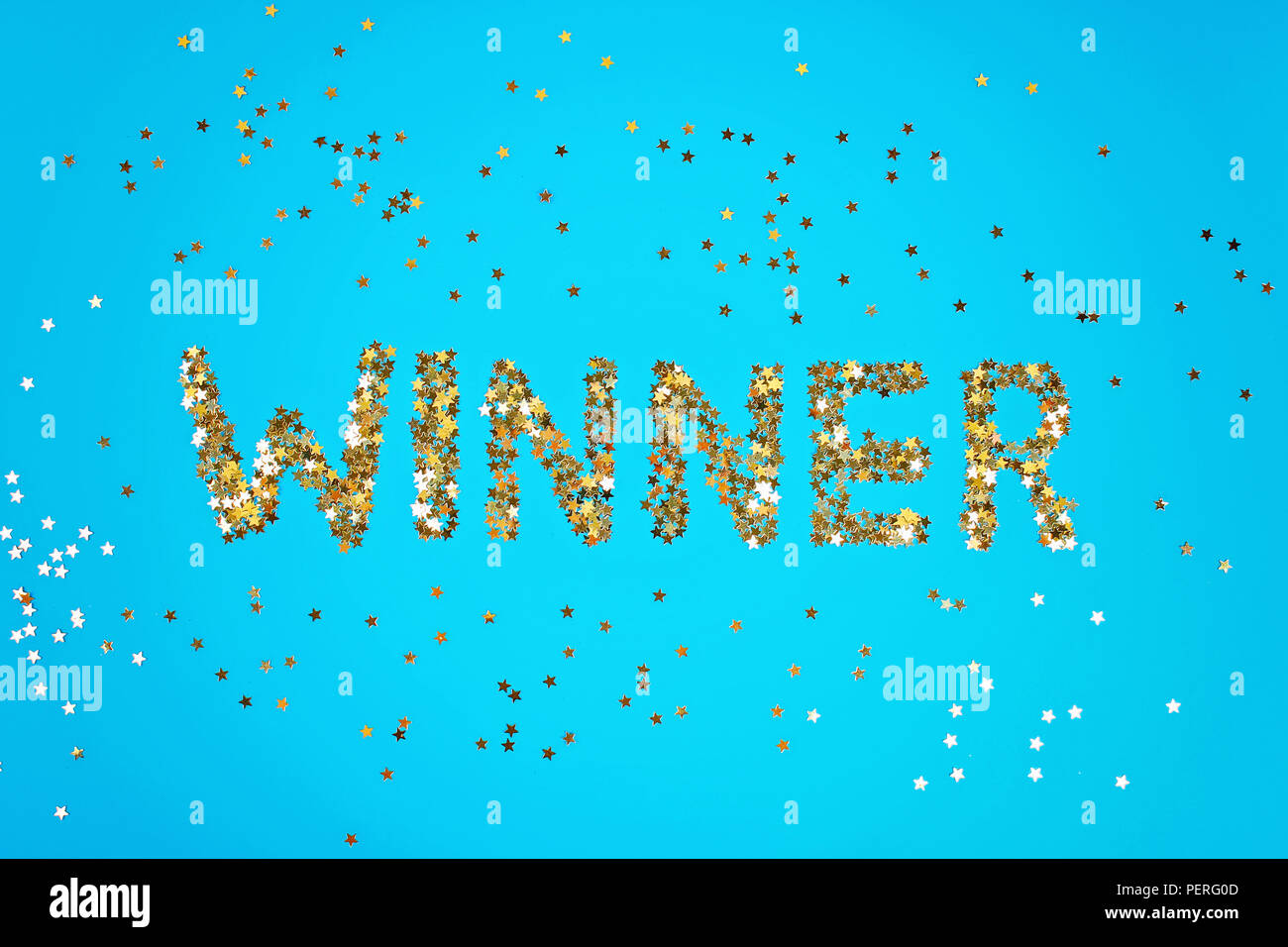 The word Winner is laid out of starry confetti on a blue background ...