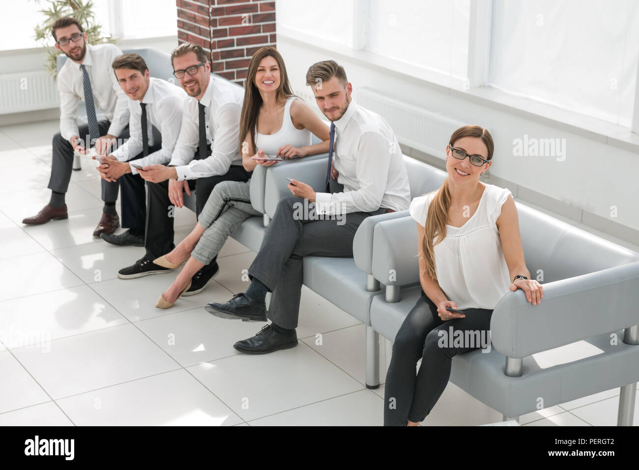 group of employees sitting in the lobby of a modern office Stock Photo ...