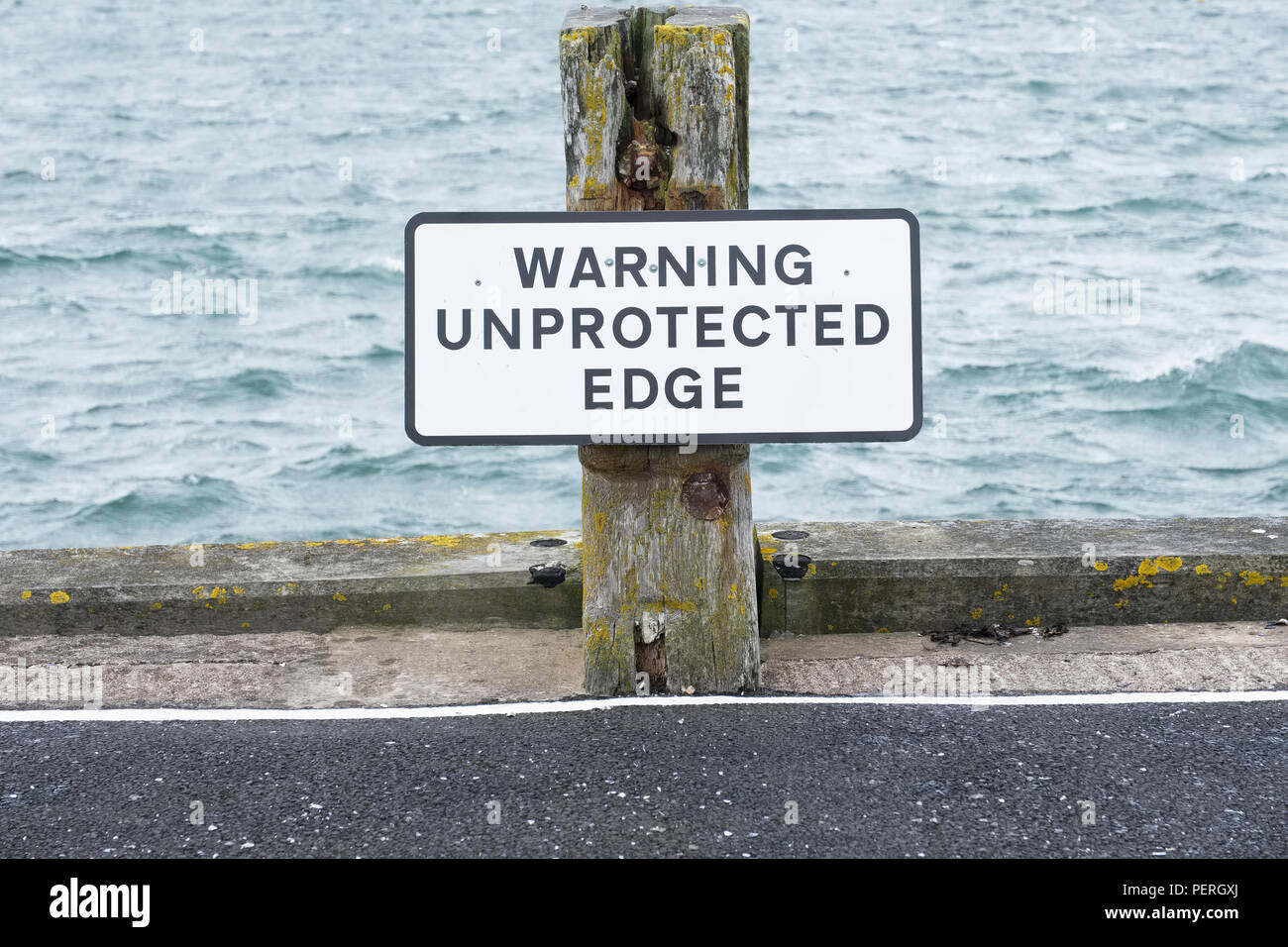 Unprotected edge warning sign at harbour port for car and vehicle ...