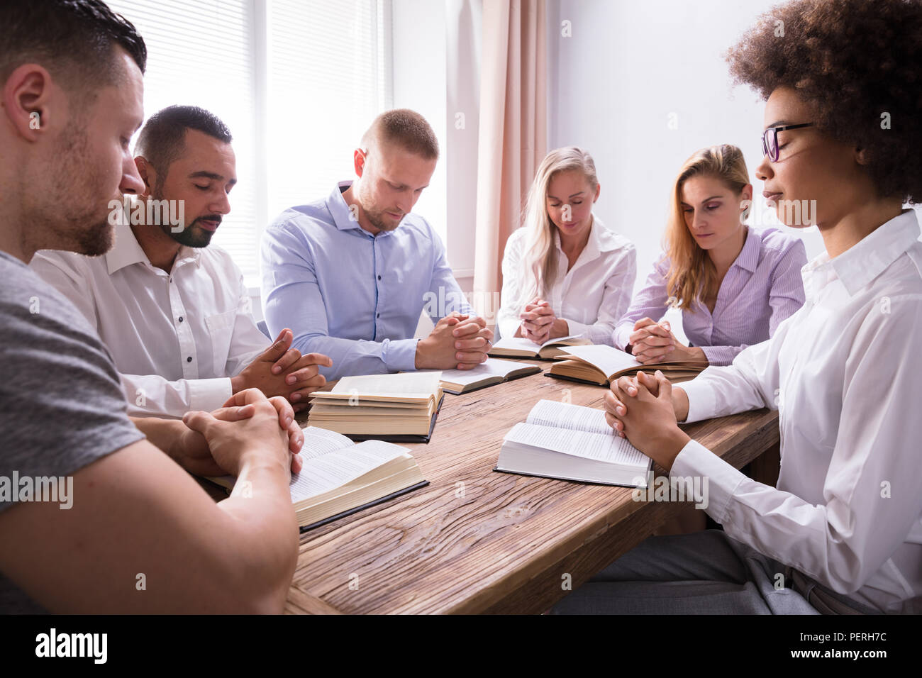 Group Of Young Multiethnic People Reading Bible Over Wooden Desk Stock ...