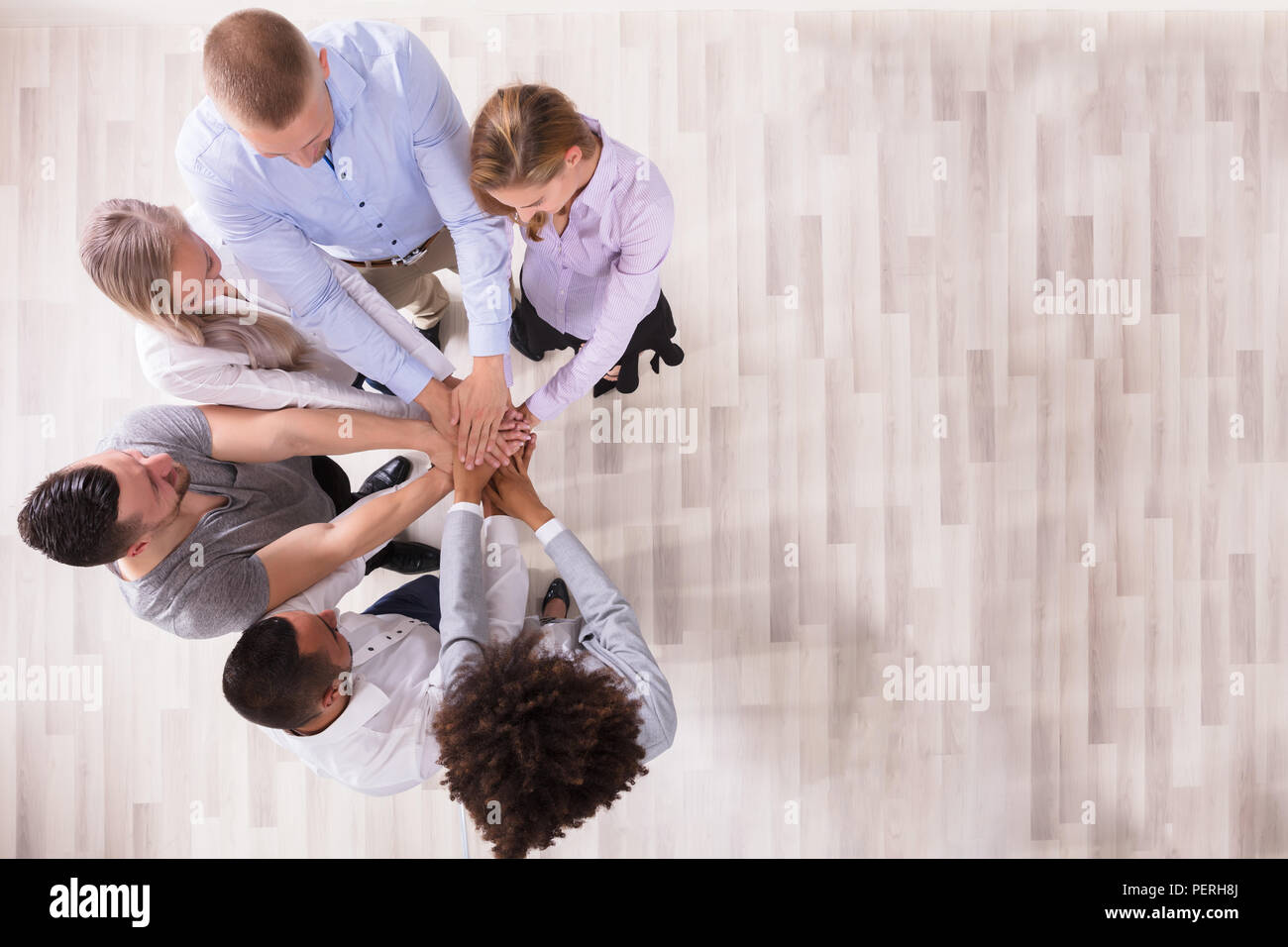 High Angle View Of Team Stacking Their Hands Stock Photo - Alamy