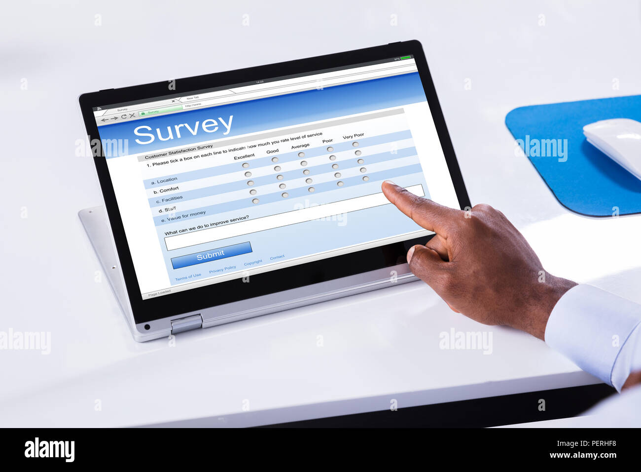 Close-up Of A Businessman's Hand Filling The Survey Form On Laptop Over ...