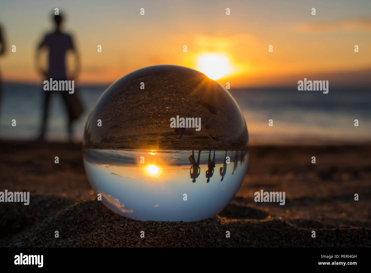 Sunset on Beach with Silhouette People Taken Through Glass Ball Stock ...