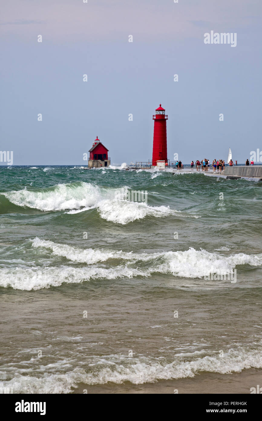 Big waves on Lake Michigan, USA, with pier and lighthouse in background ...