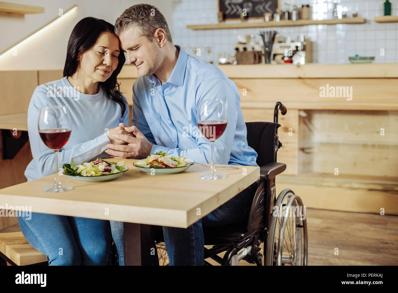 Disabled man hugging a woman Stock Photo - Alamy
