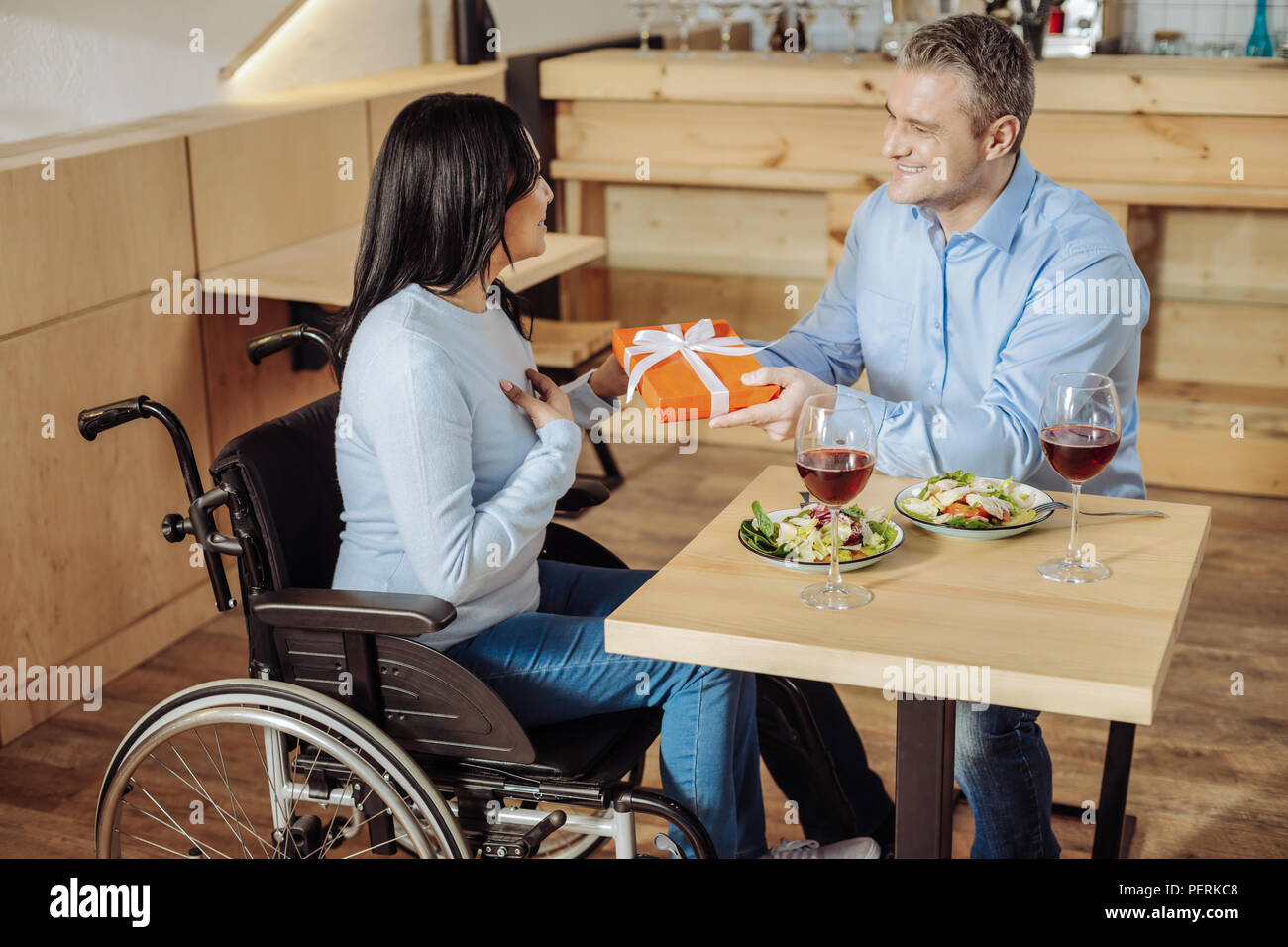 Surprised woman receiving a gift Stock Photo - Alamy