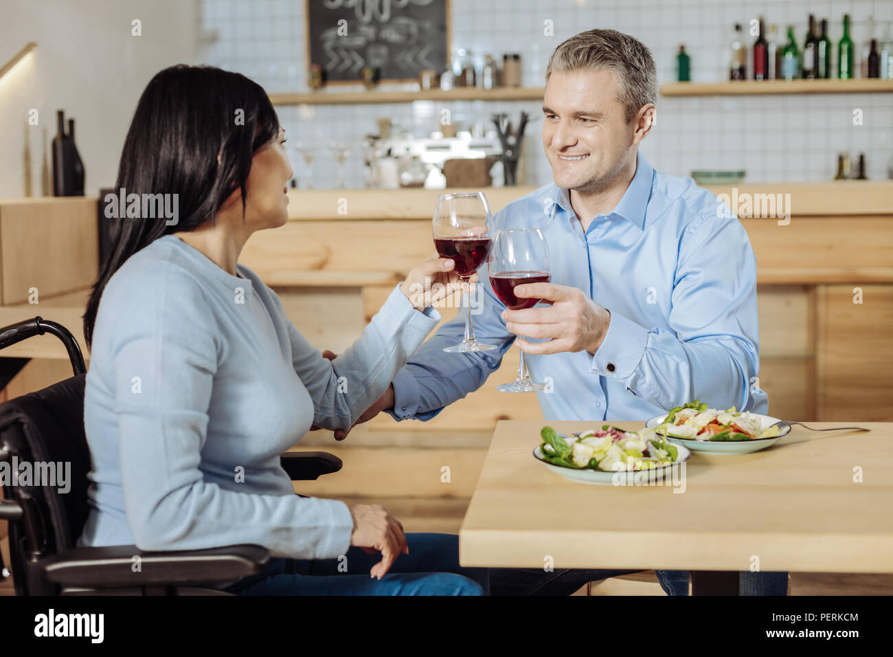 Paralyzed lady having dinner with a man Stock Photo - Alamy