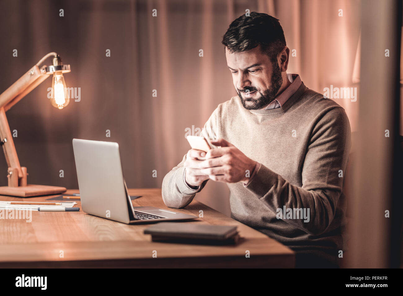 Excited man answering a message Stock Photo - Alamy