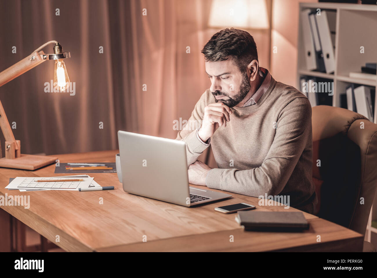 Concentrated man looking at the screen Stock Photo - Alamy