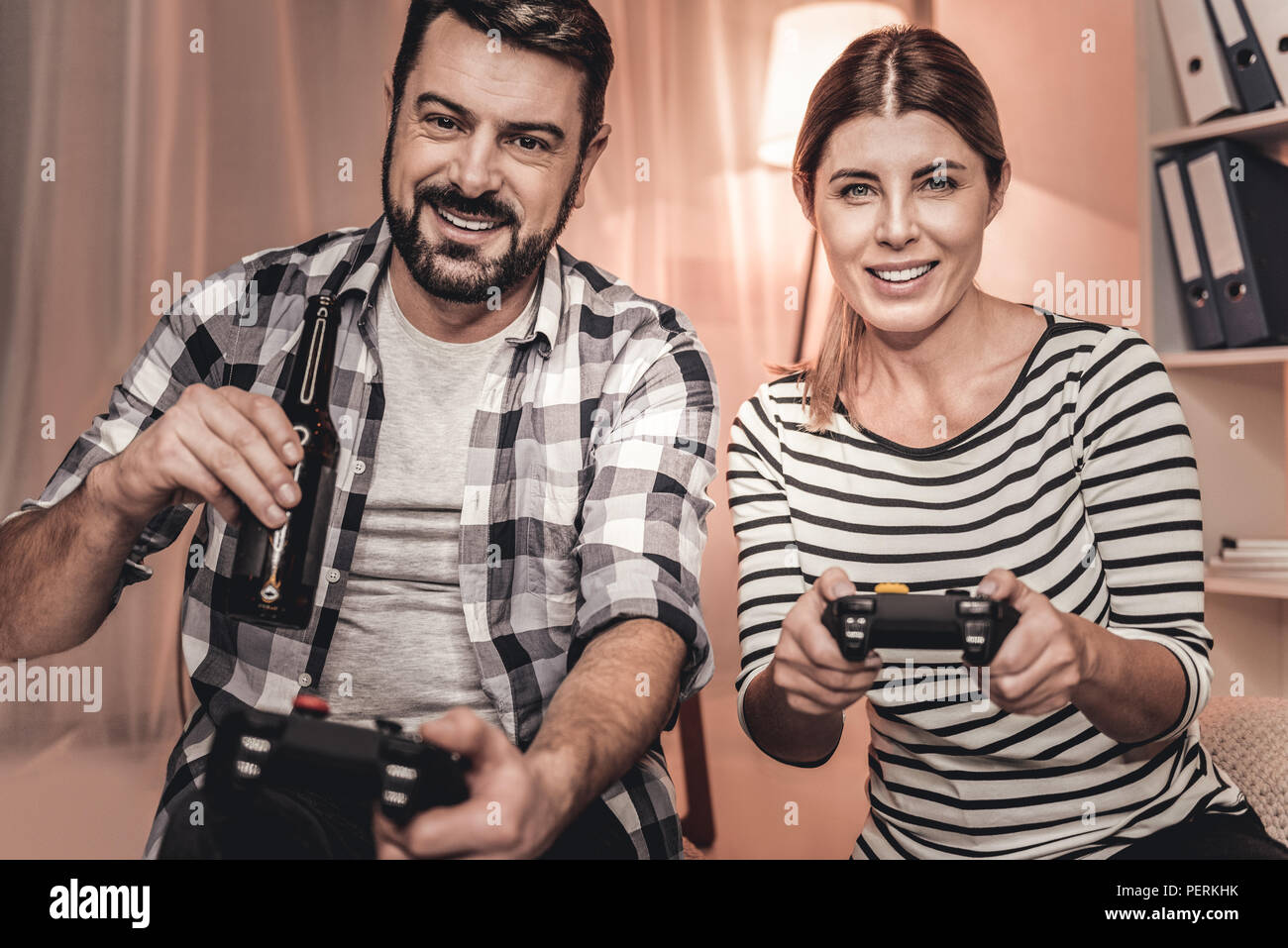 Gorgeous man and woman playing a video game Stock Photo - Alamy
