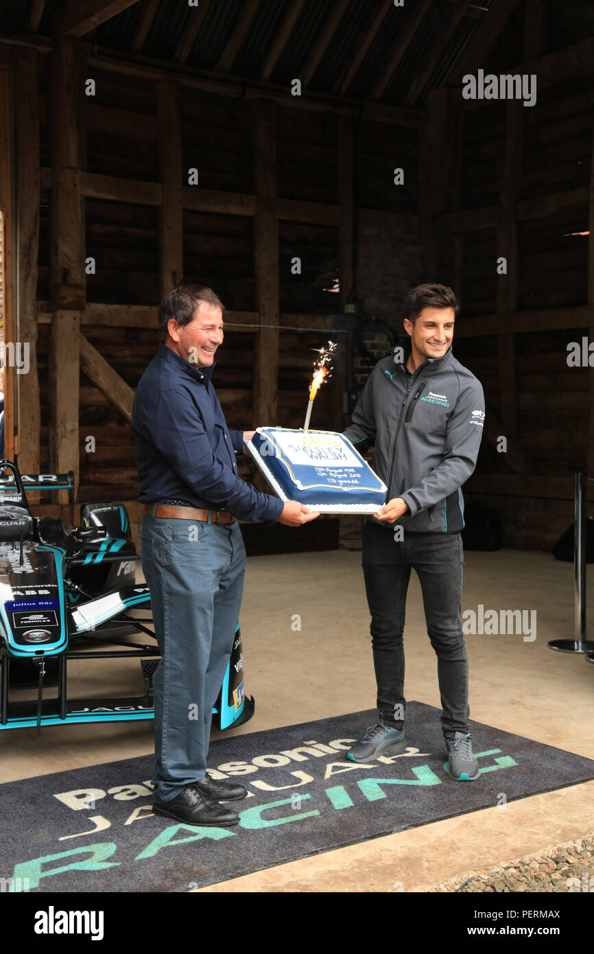 Martin Groves and Mitch Evans hold a birthday cake celebrating the ...