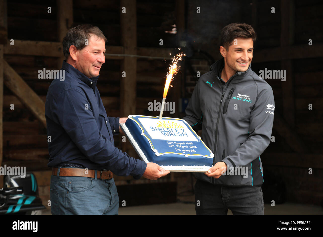 Martin Groves and Mitch Evans hold a birthday cake celebrating the ...