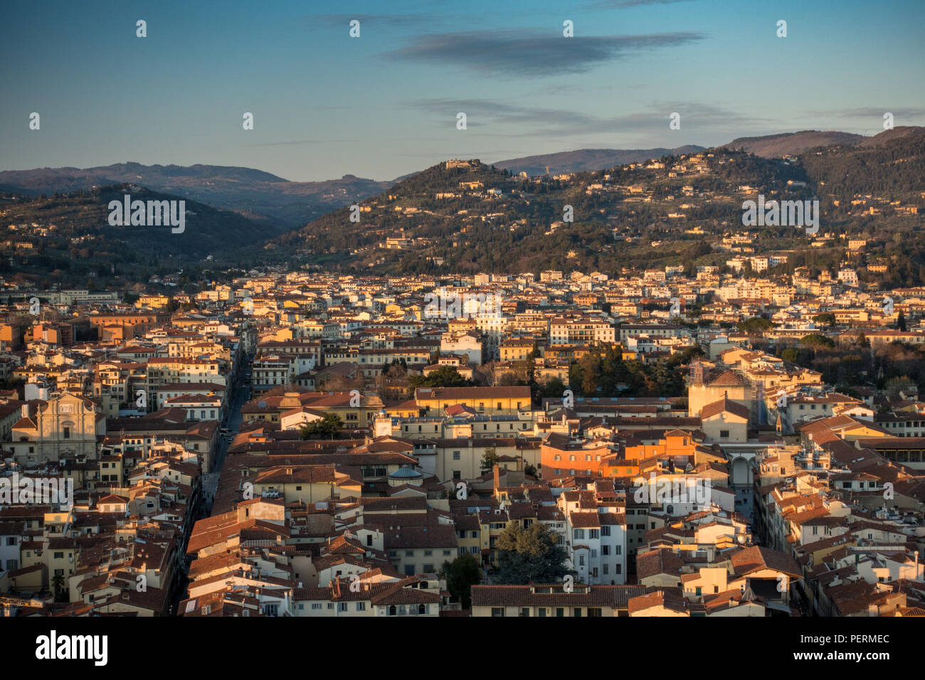 Florence, Italy - March 23, 2018: Evening sun shines on the rooftops of ...