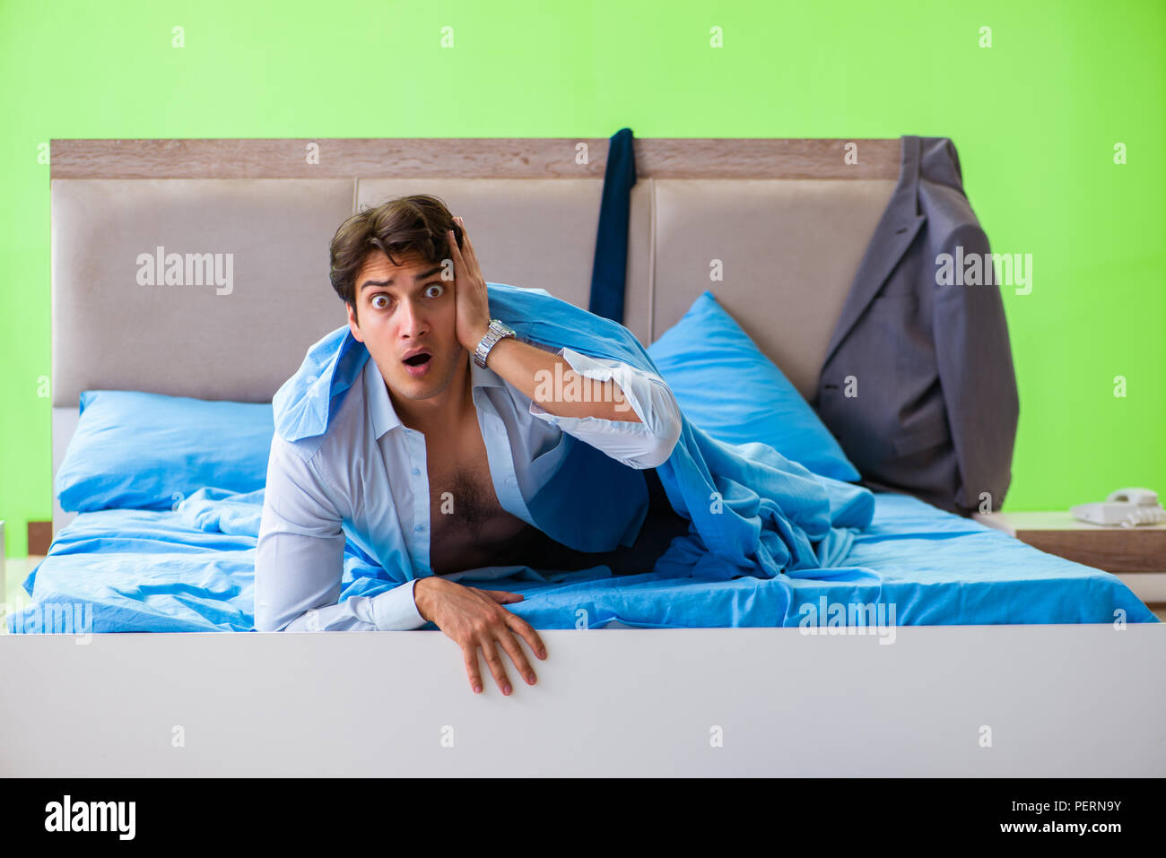 Employee in the bedroom being late for his job Stock Photo - Alamy