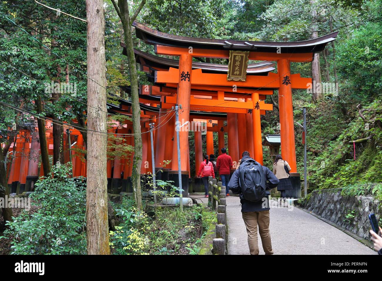 KYOTO, JAPAN - NOVEMBER 28, 2016: People visit tori gates of Fushimi ...
