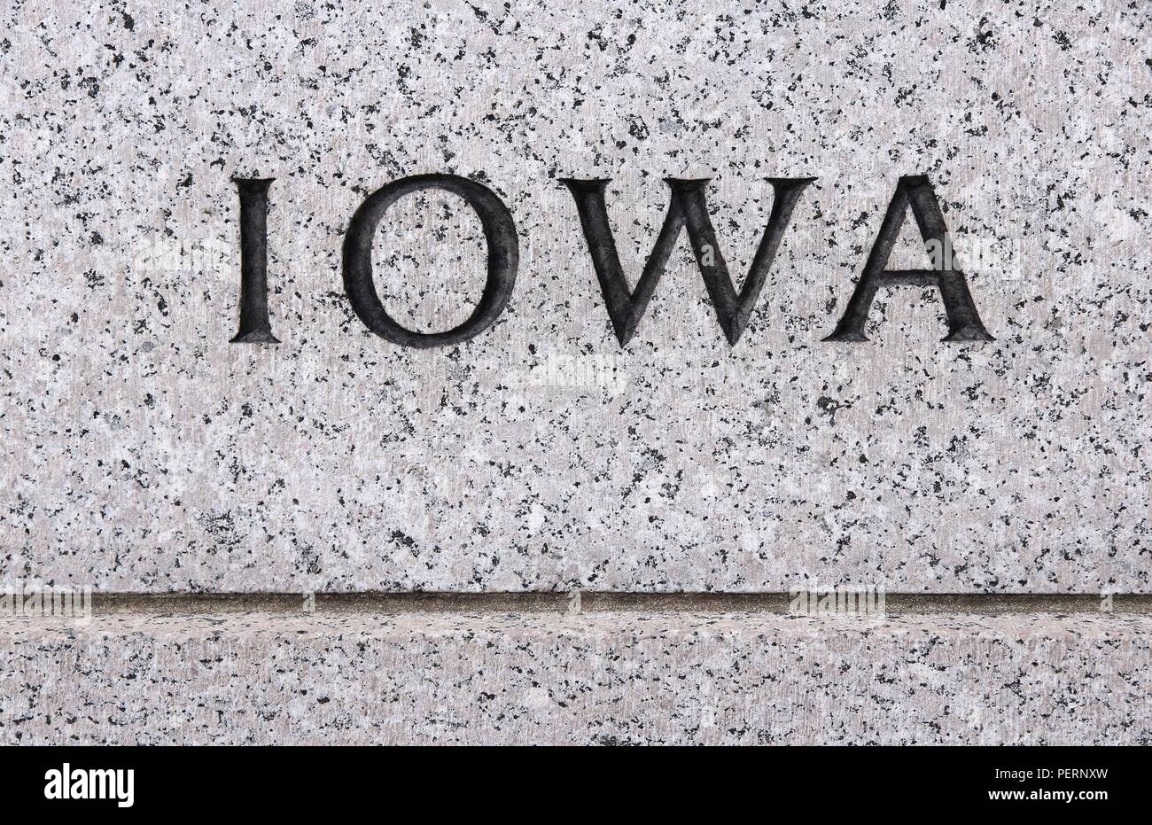 Iowa - US state name carved in grey granite stone Stock Photo - Alamy