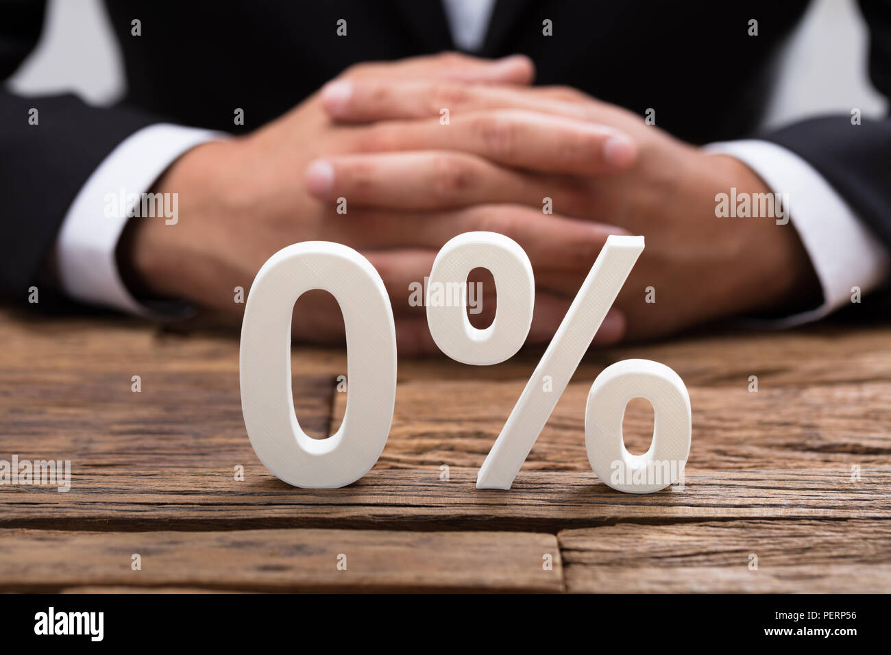 White zero percentage symbol in front of businessperson's hand Stock ...