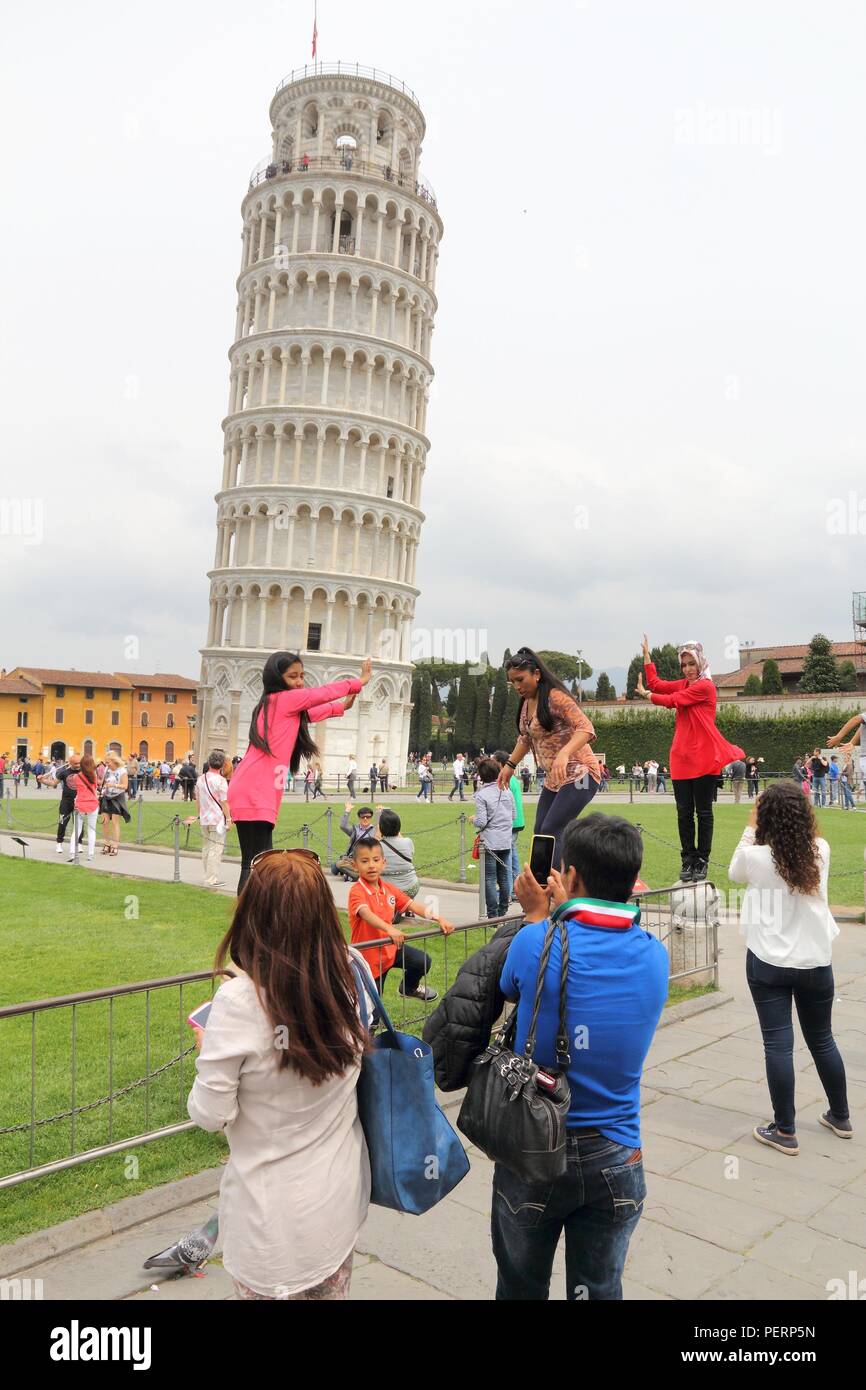 PISA, ITALY - APRIL 25, 2015: Tourists pose and take photos with ...