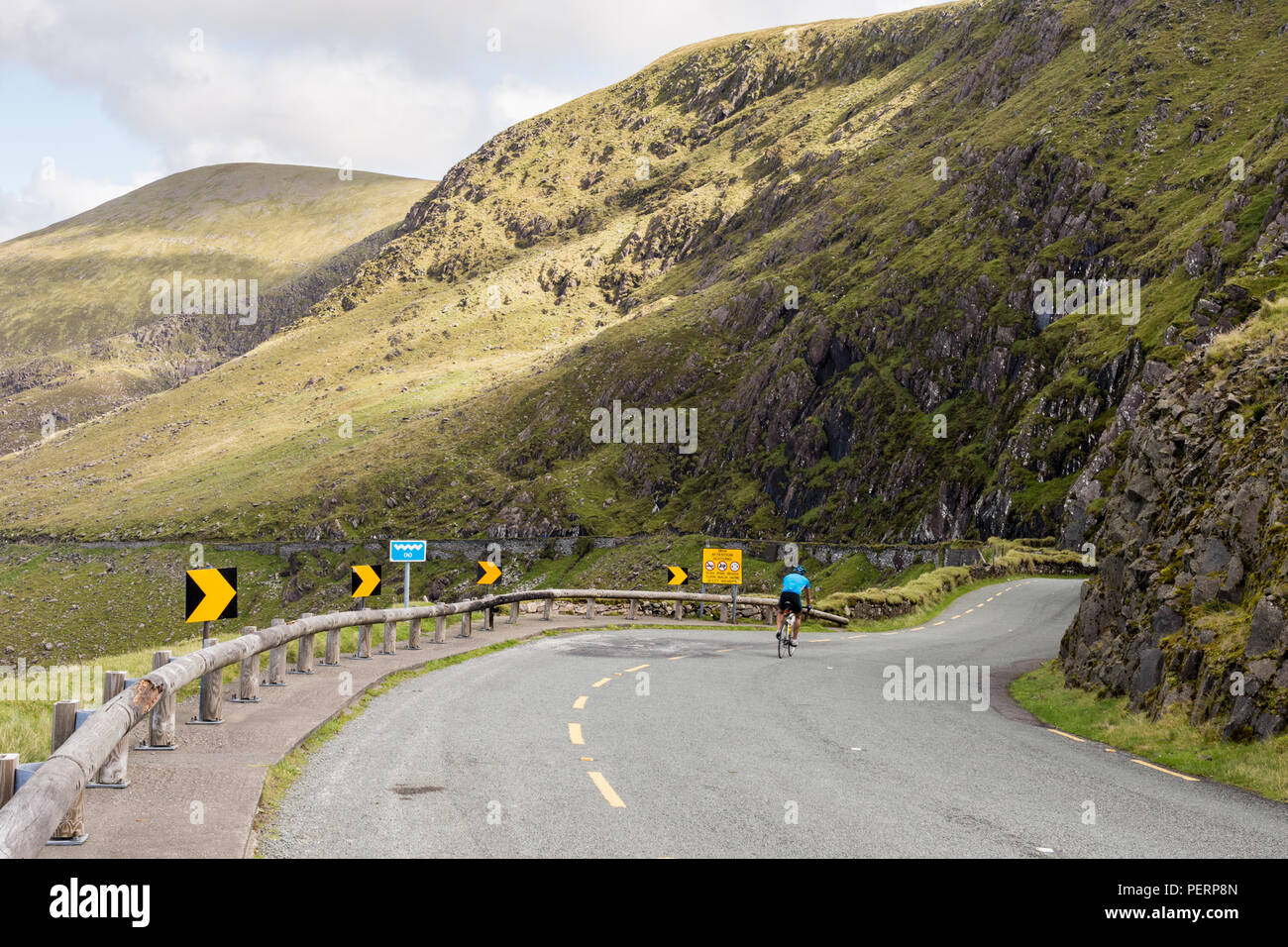 A cyclist descends the narrow, winding and precipitous Conor Pass road ...