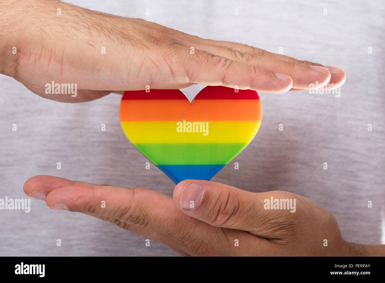 Person holding a gay pride flag hi-res stock photography and images - Alamy