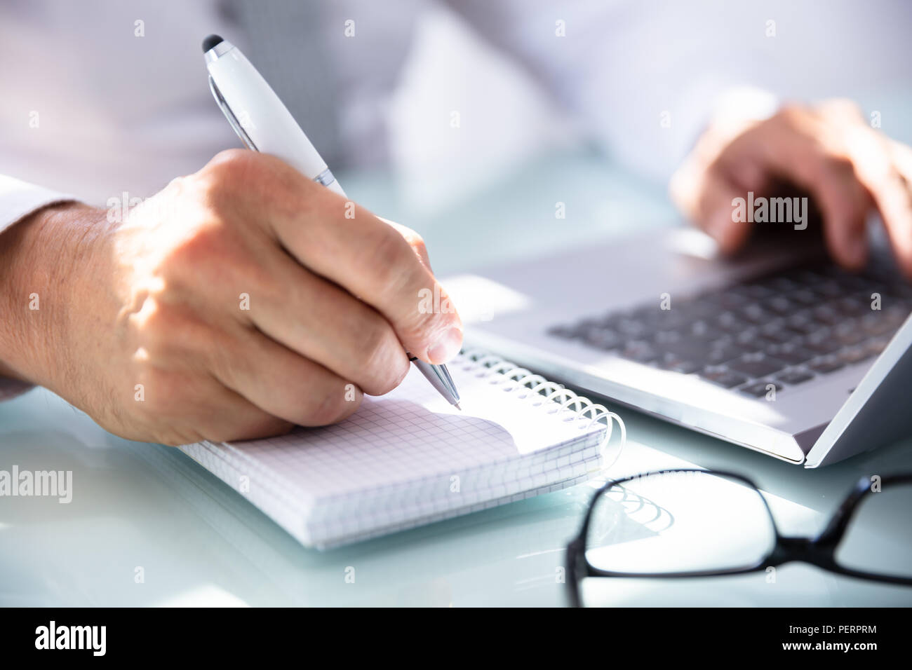 Close-up Of A Businessman's Hand Writing In Diary Over Desk Stock Photo ...