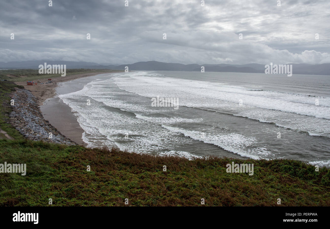 Waves break on the beach at Inch Strand, a sand dune system in Dingle ...
