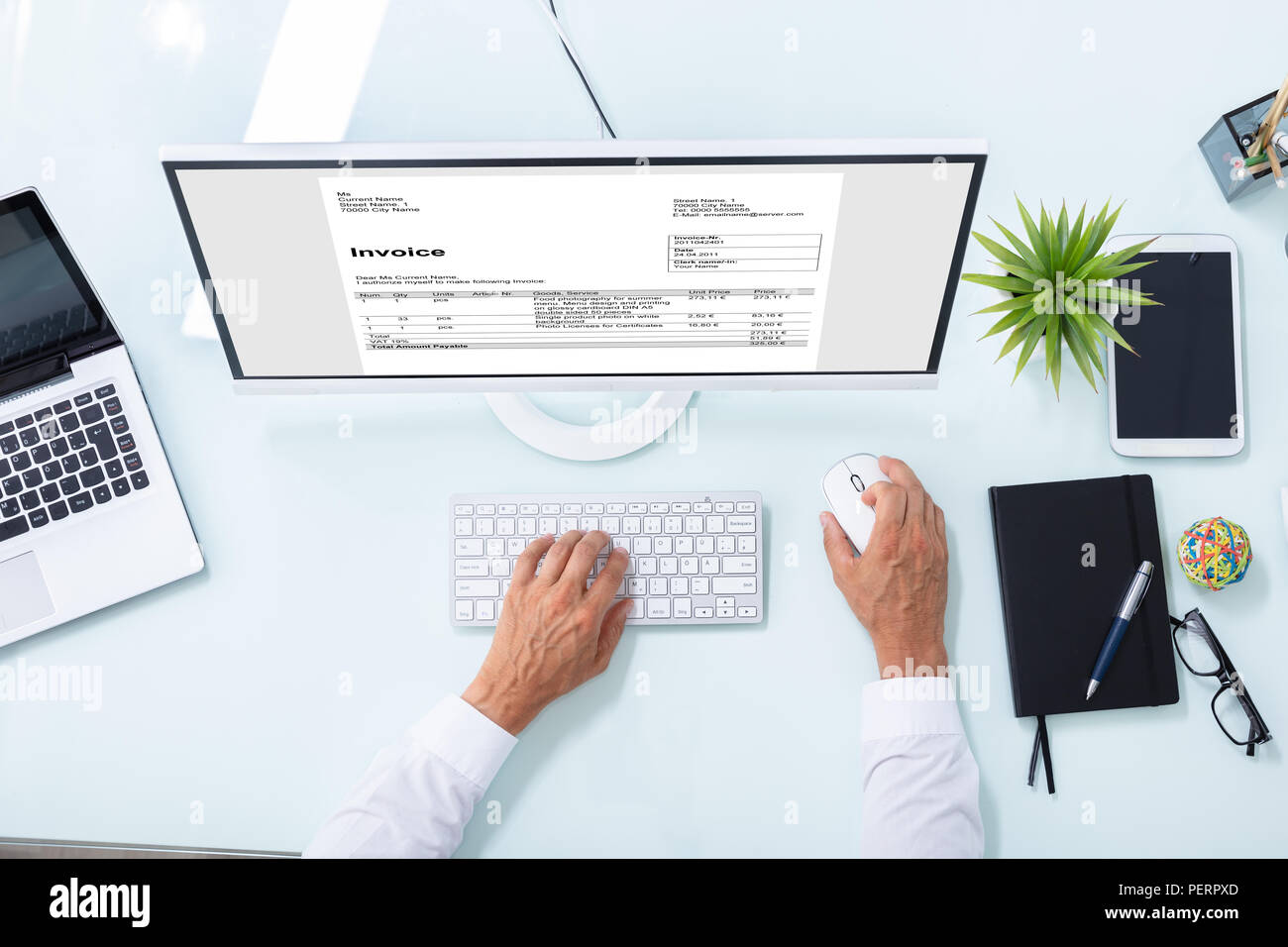 Elevated View Of A Businessman's Hand Checking Invoice On Computer ...