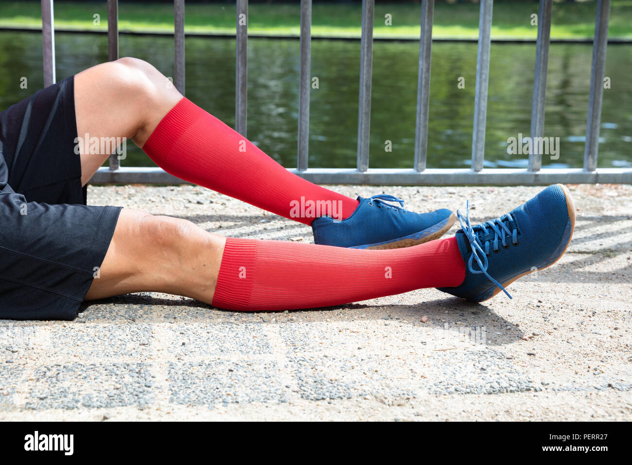 Low Section View Of A Male Jogger's Feet In Front Of Railing Stock ...